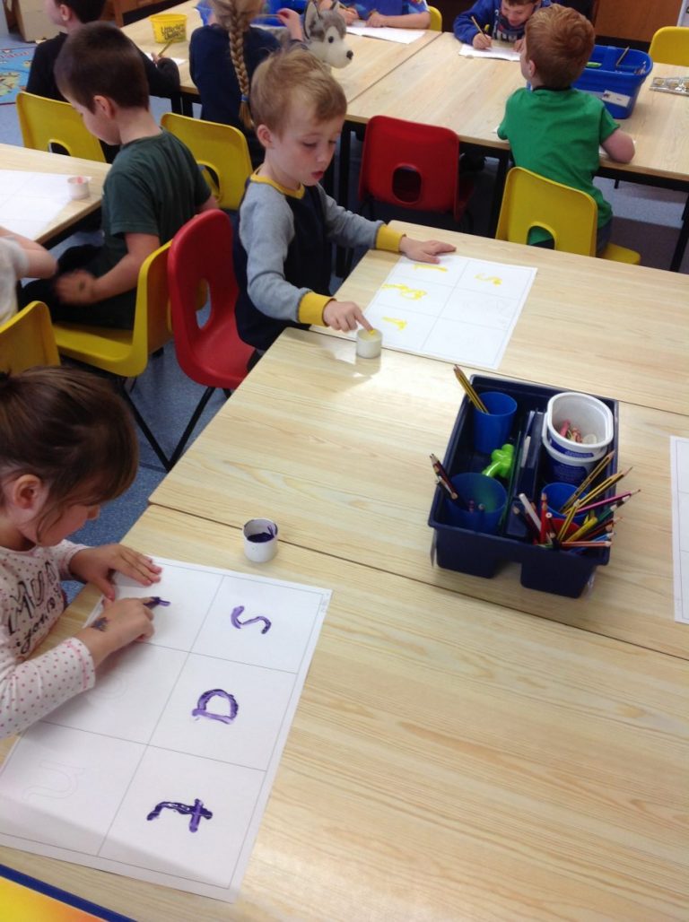 Writing letters using finger paints | Aith Primary Department